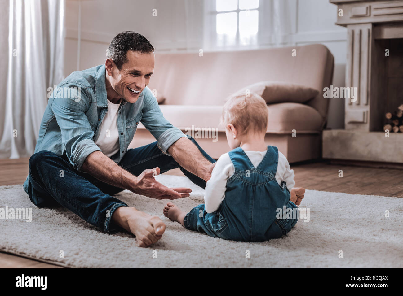 Nice joyful man looking after the child Stock Photo - Alamy