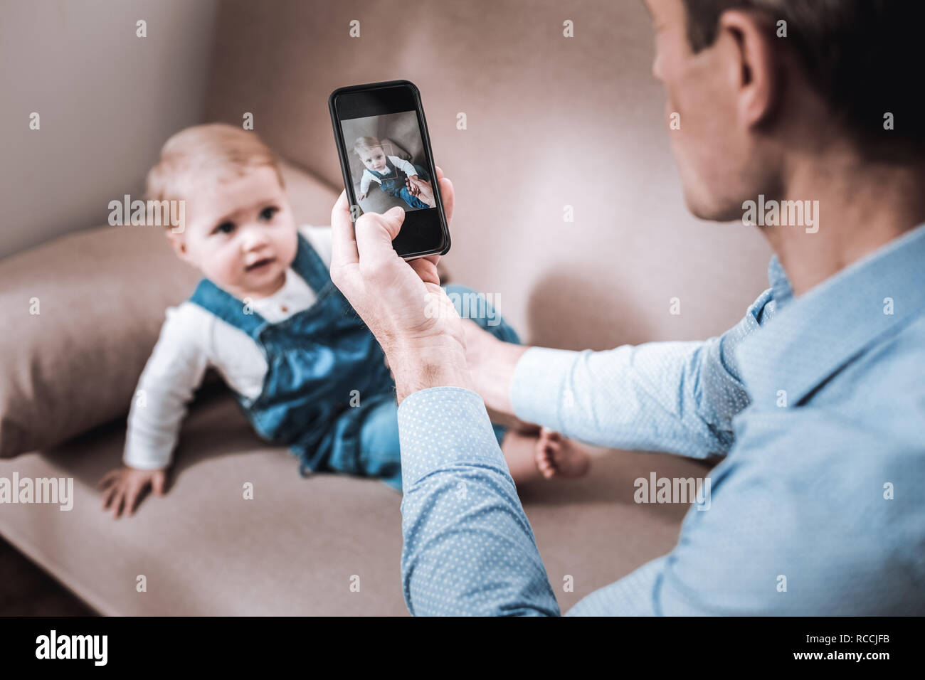 Nice happy man taking a photo Stock Photo - Alamy