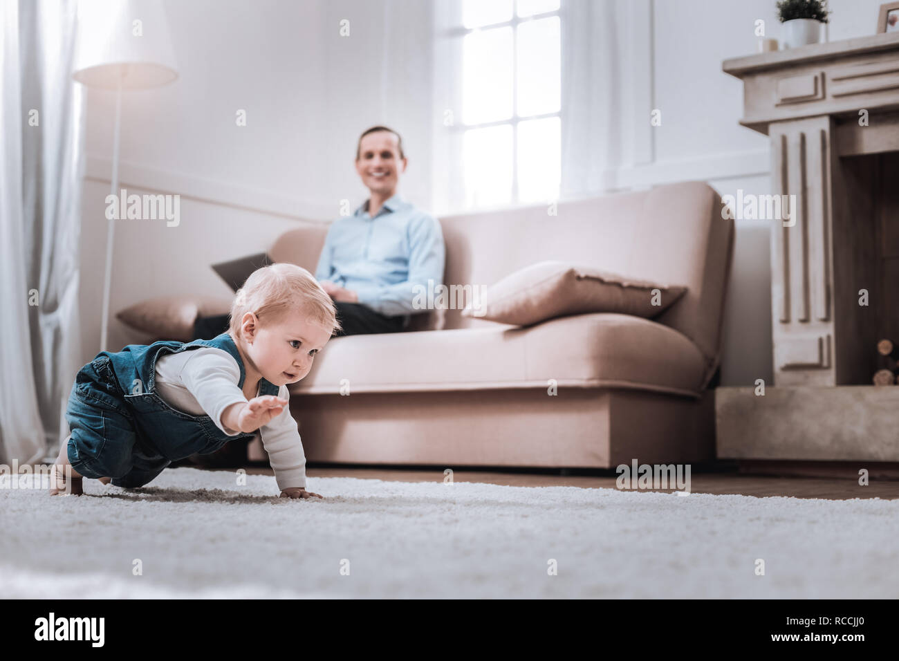 Nice cute baby exploring the room Stock Photo - Alamy