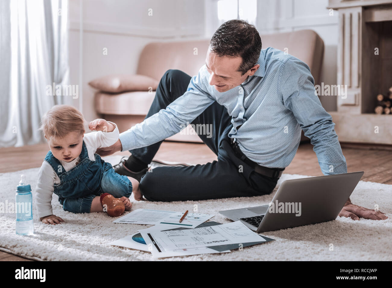 Positive handsome man looking at his child Stock Photo - Alamy