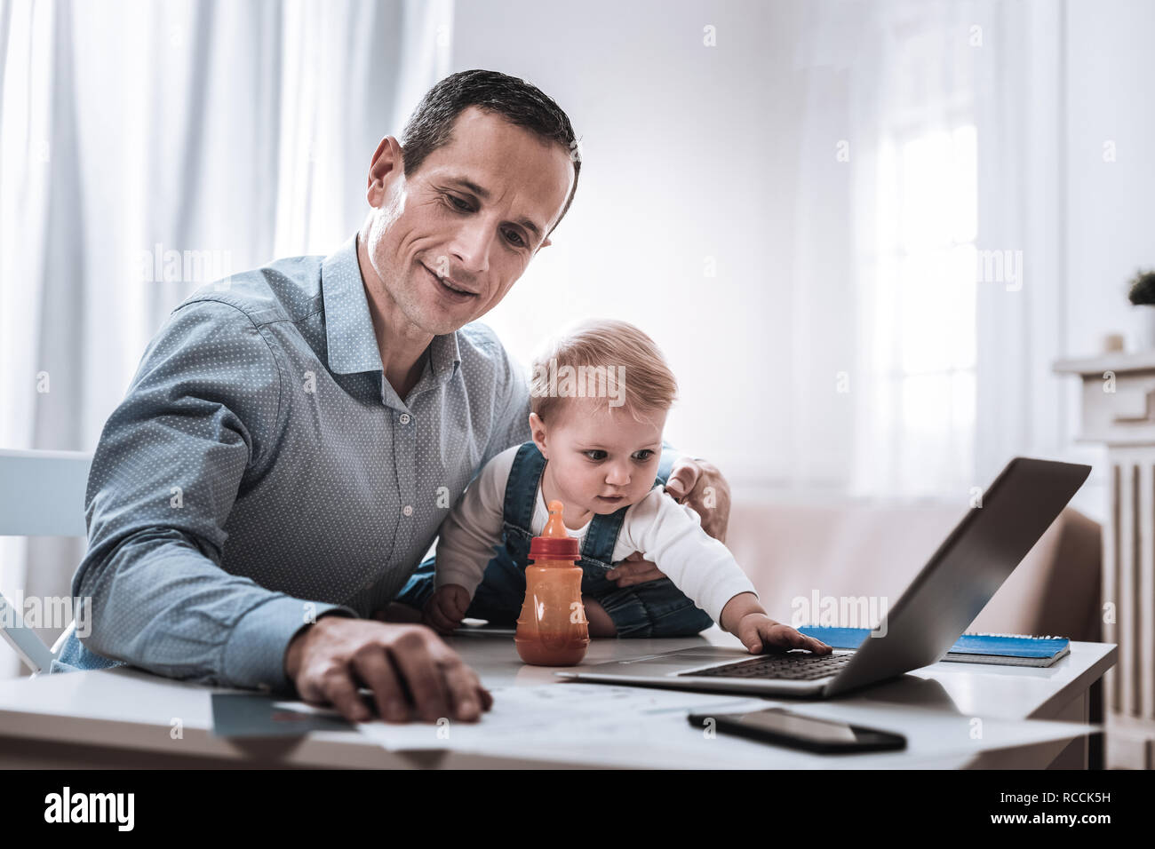 Positive smart man doing his work Stock Photo - Alamy