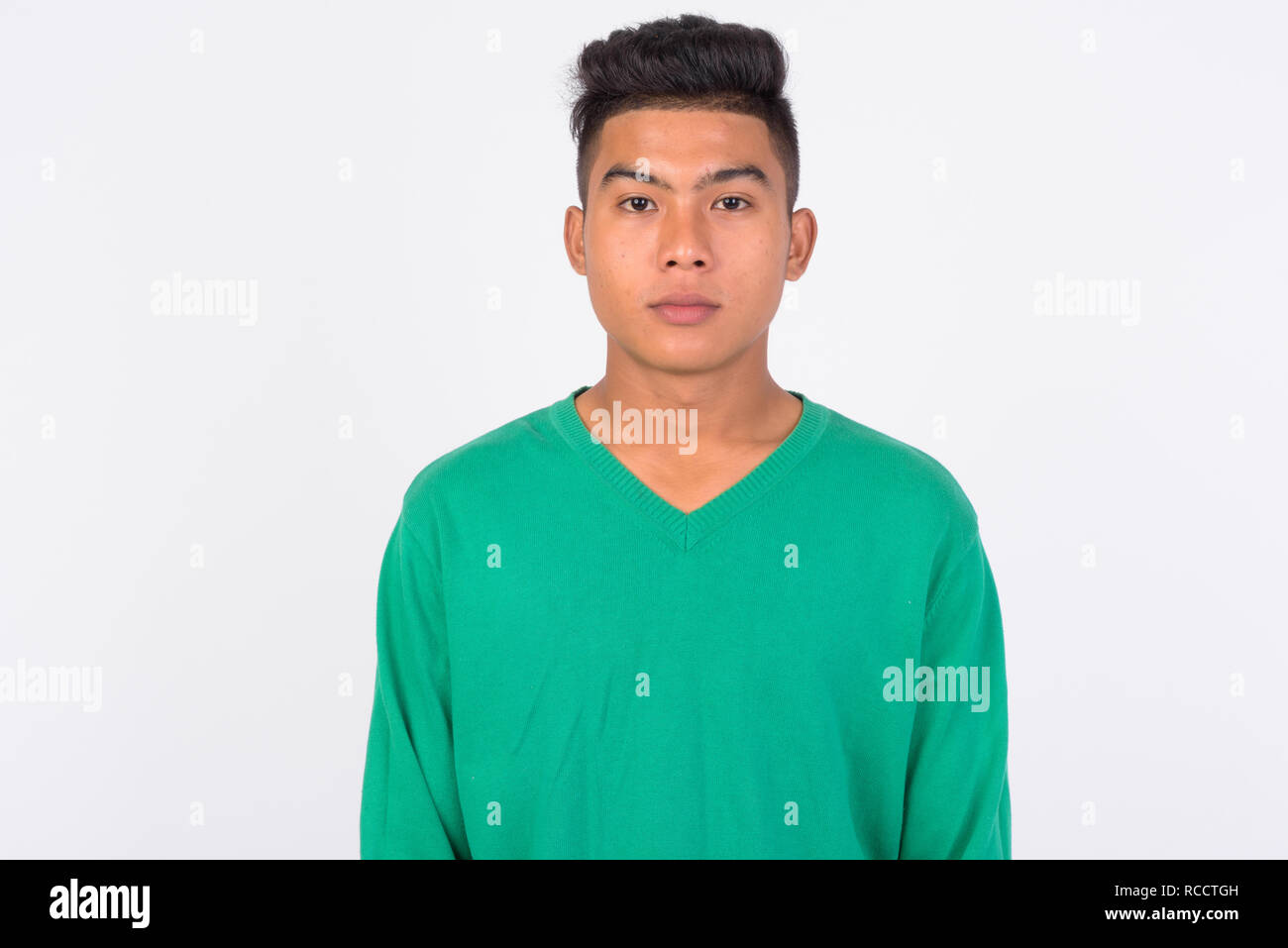 Young Asian man looking at camera against white background Stock Photo ...