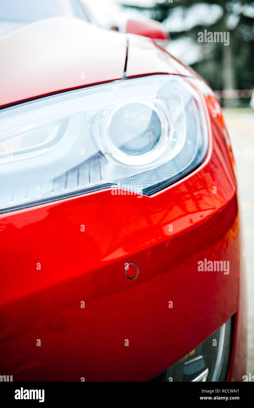 PARIS, FRANCE - NOV 29, 2014: New red Tesla Model S detail of the bi ...