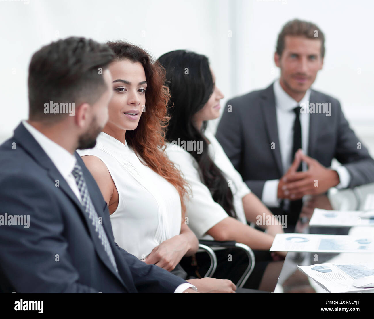 business team sitting near the desktop Stock Photo - Alamy