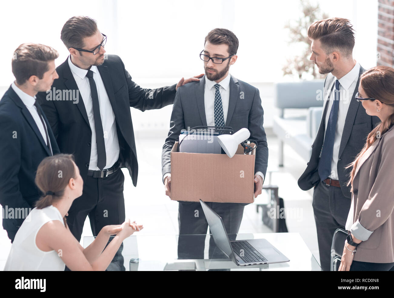 business team and frustrated employee with personal things Stock Photo ...