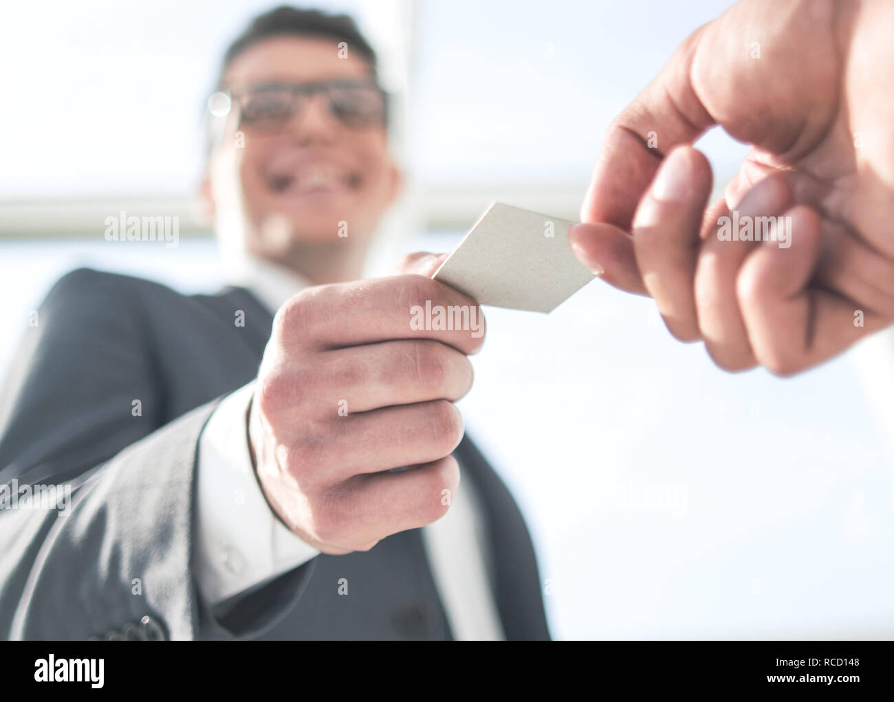 Two businessmen exchanging business card hi-res stock photography and ...