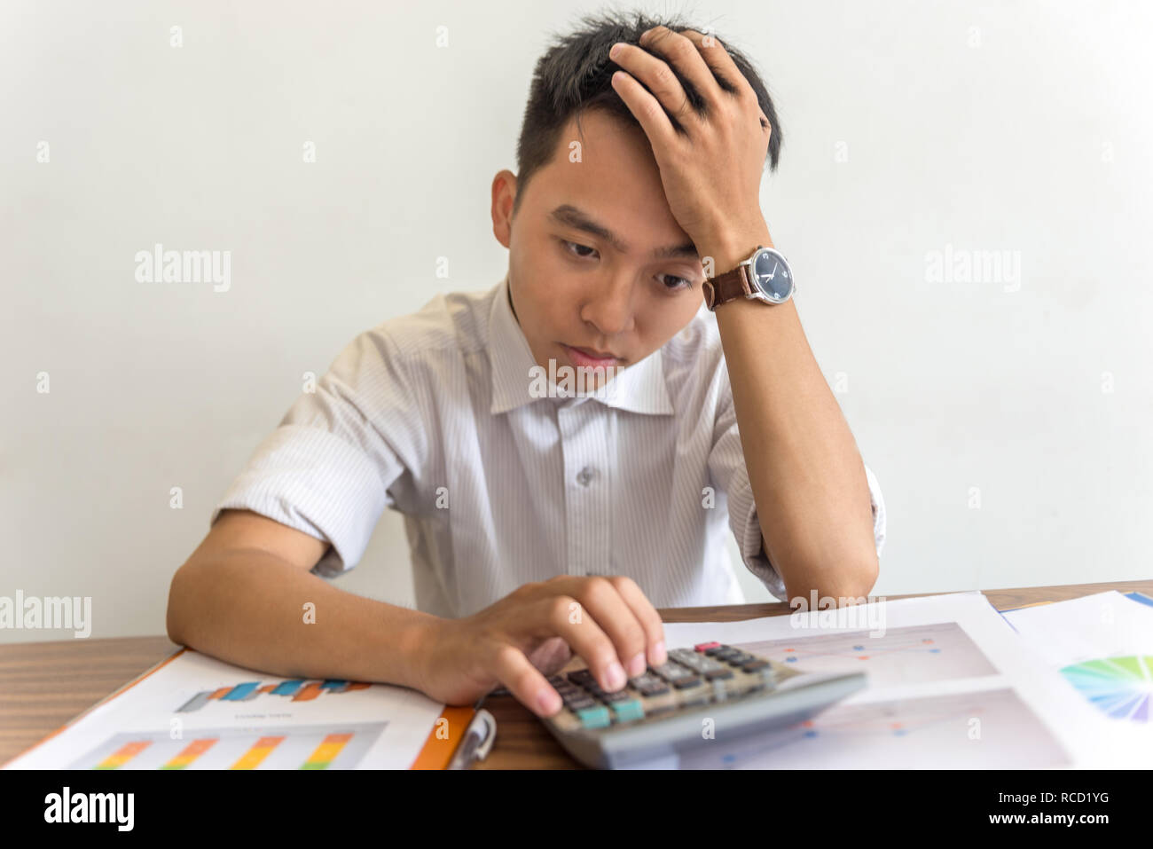 Young man thinking of financial solution Stock Photo - Alamy