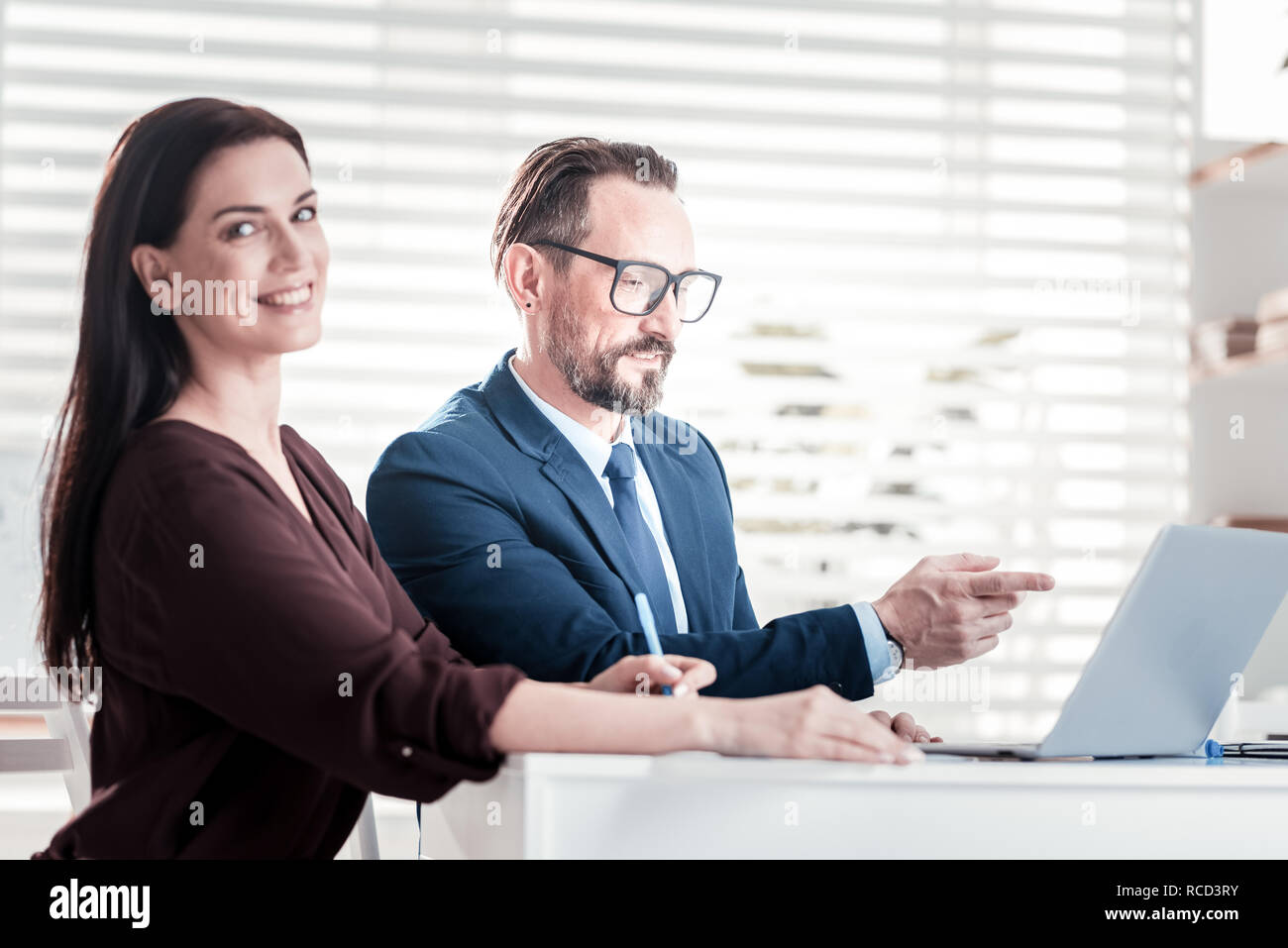 Positive two colleagues working together Stock Photo - Alamy