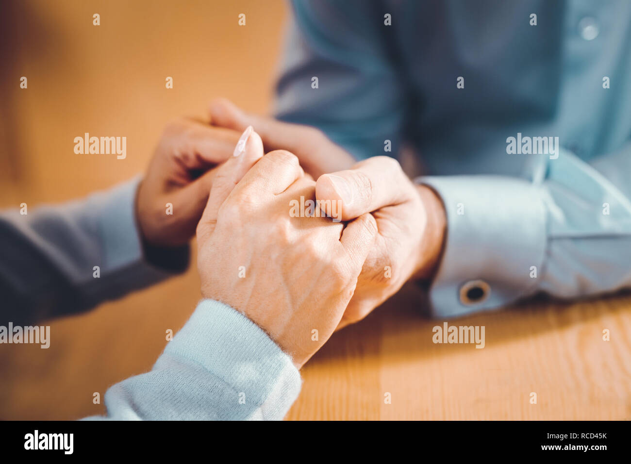 Enamored man and woman holding hands Stock Photo - Alamy