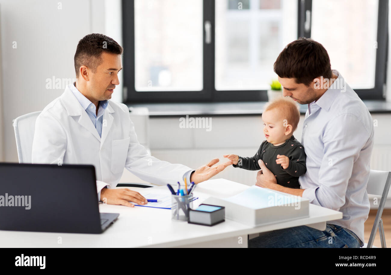 father with baby and doctor at clinic Stock Photo - Alamy