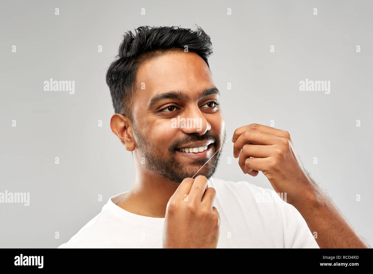 indian man with dental floss cleaning teeth Stock Photo - Alamy
