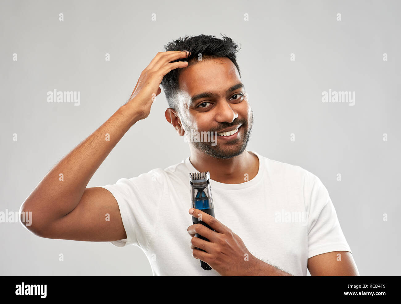 Indian man styling hair hi-res stock photography and images - Alamy