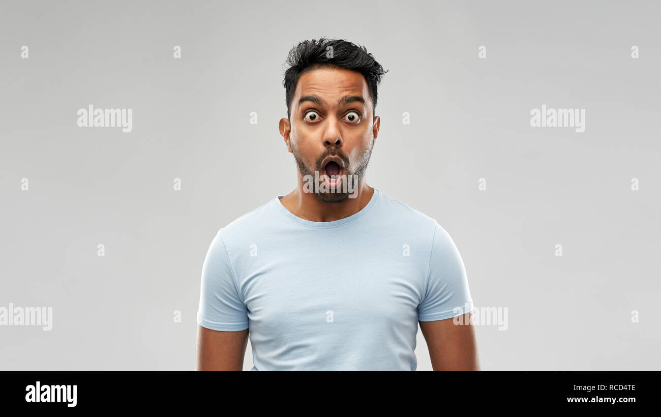 shocked or scared man over grey background Stock Photo - Alamy