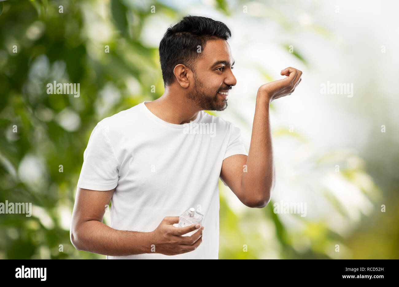 happy indian man with perfume Stock Photo - Alamy