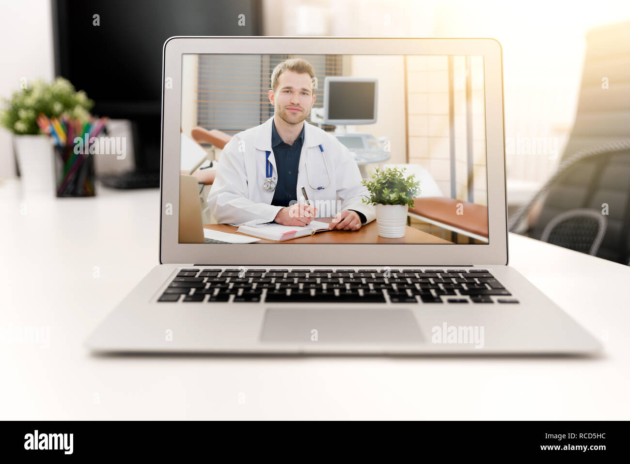 Doctor with a stethoscope on the computer laptop screen. Telemedicine ...