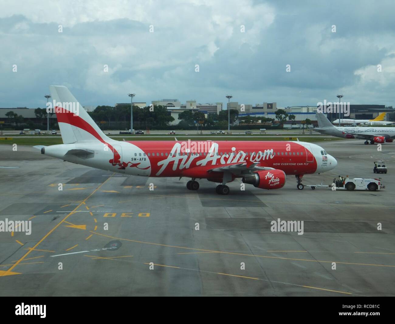 AirAsia Airbus A320-214 9M-AFB Leaving Jet Bridge by Tractor in ...