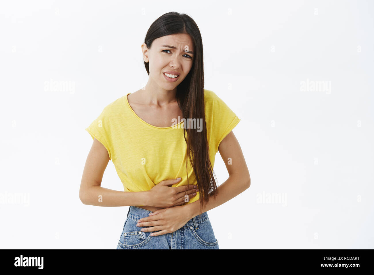 Woman stooping hi-res stock photography and images - Alamy