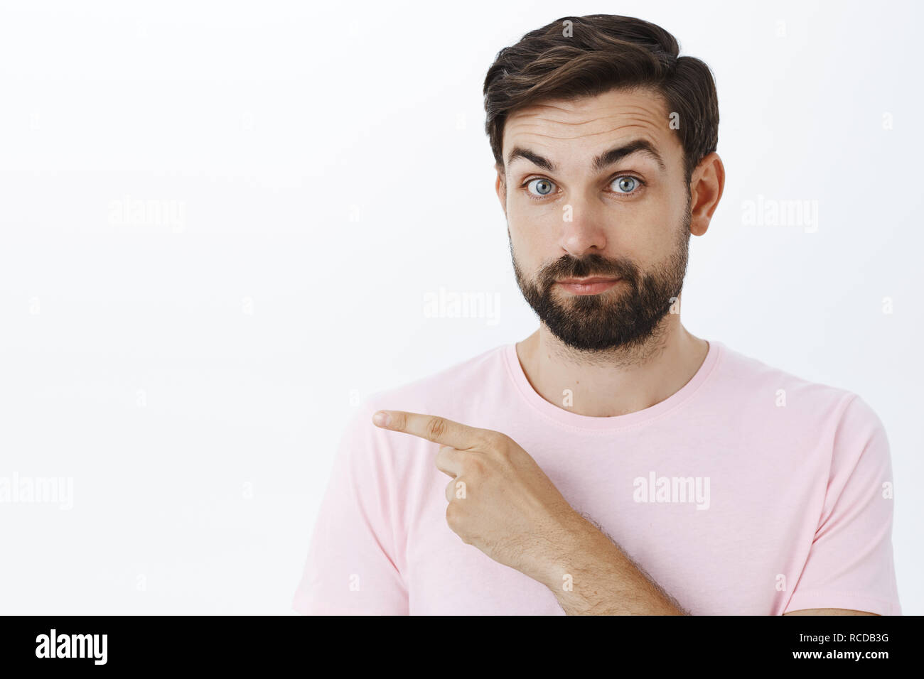 Man hinting we find answers there. Portrait of bearded guy knowing ...