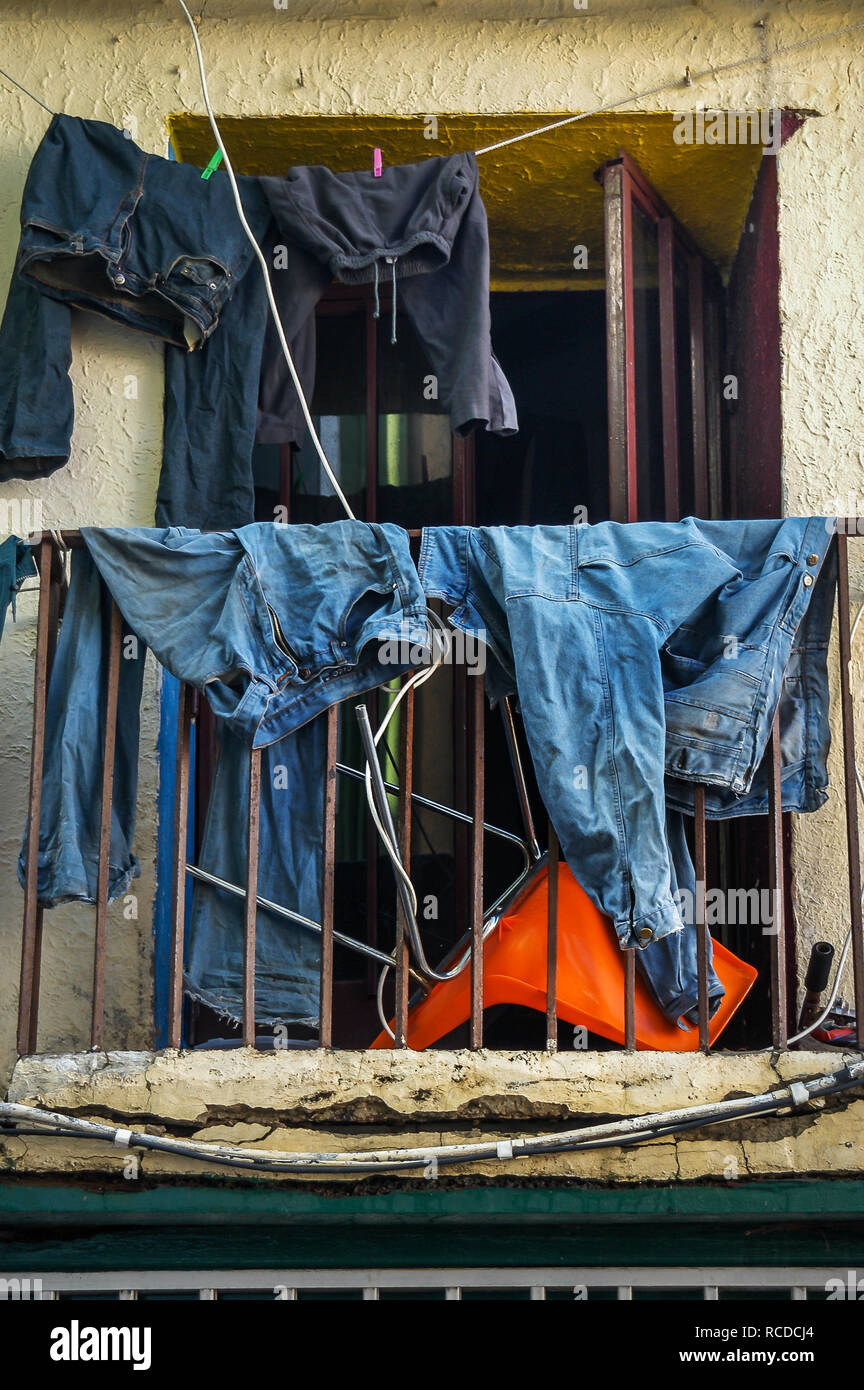 Denim clothes drying in the sun on Balcony Window Stock Photo - Alamy