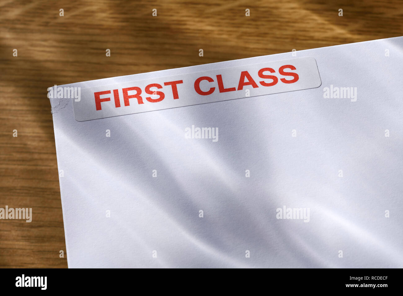 A First Class sticker on a white envelope Stock Photo - Alamy