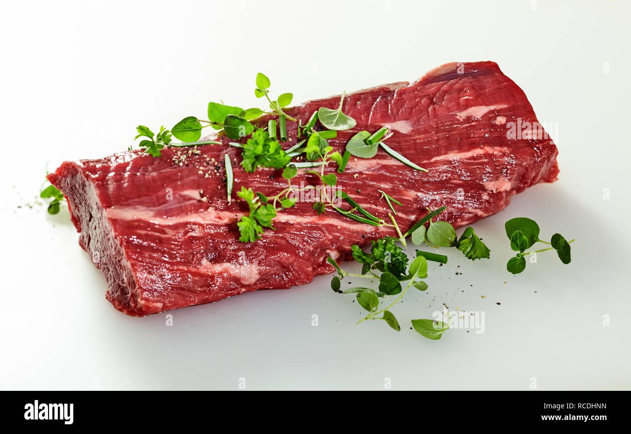 Whole raw trimmed tender fillet steak garnished with fresh watercress ...
