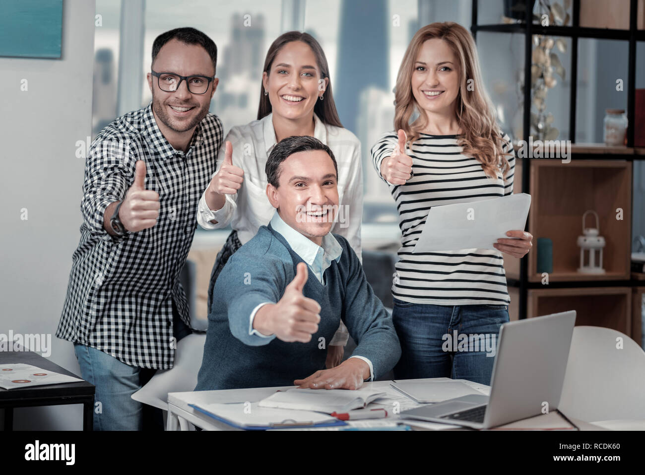 Alert colleagues showing thumbs up Stock Photo - Alamy