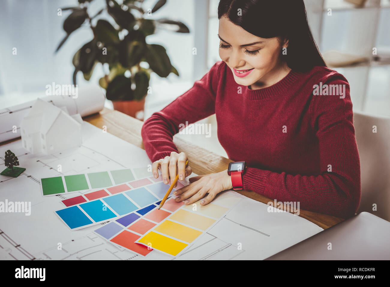 Positive happy woman choosing the color Stock Photo - Alamy