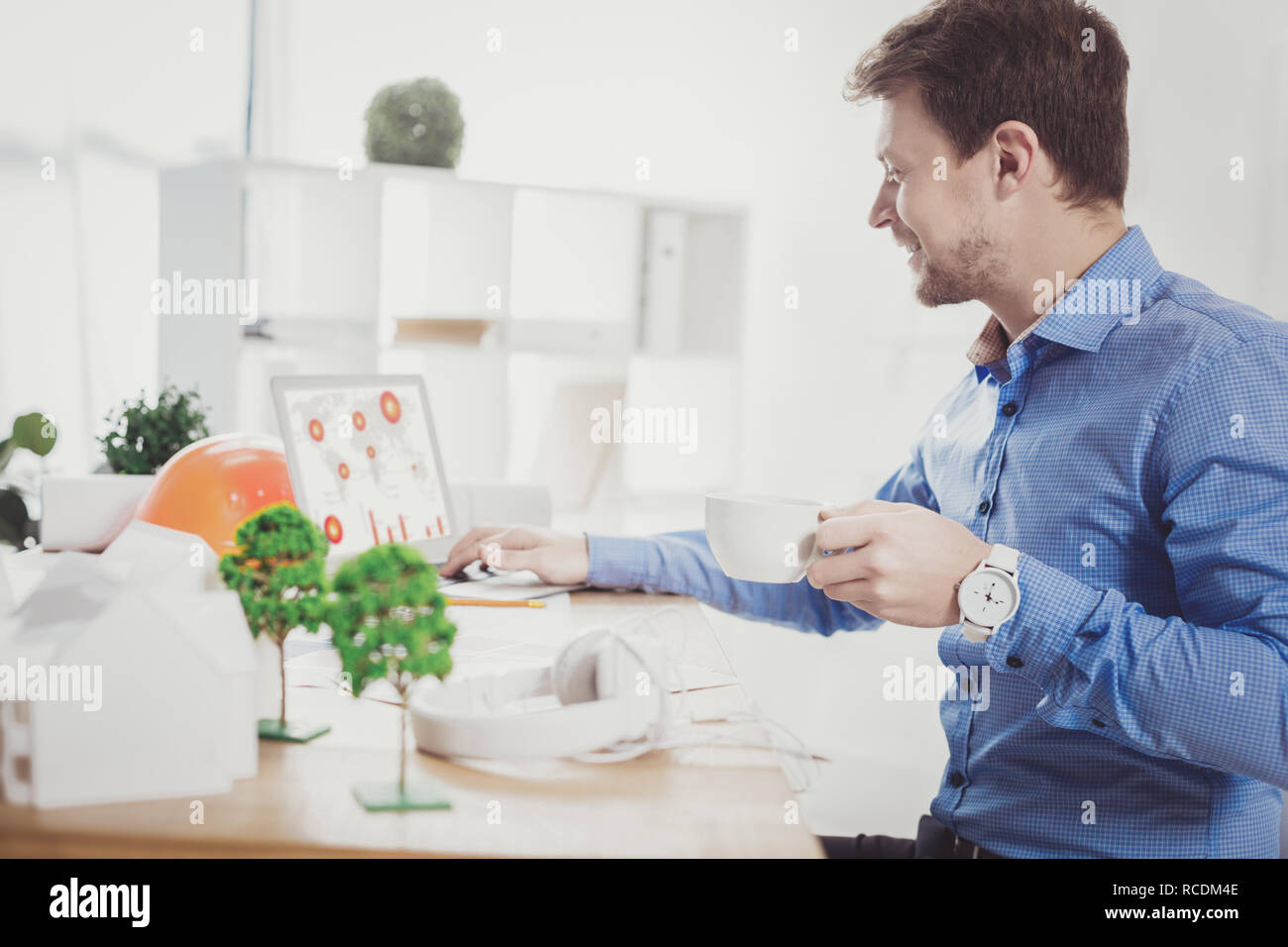 Positive nice man looking at the laptop screen Stock Photo - Alamy