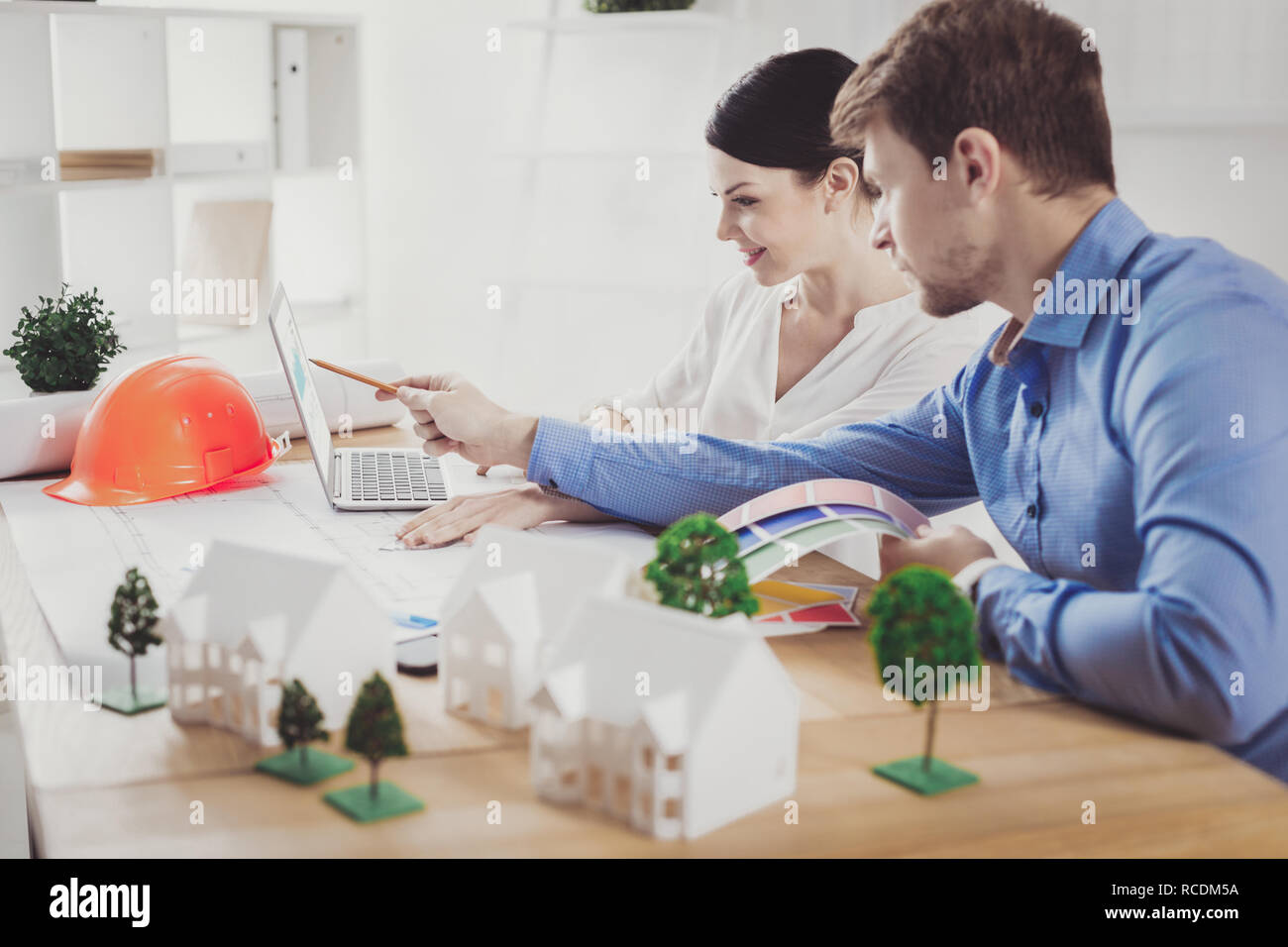 Smart nice man pointing at the screen Stock Photo - Alamy