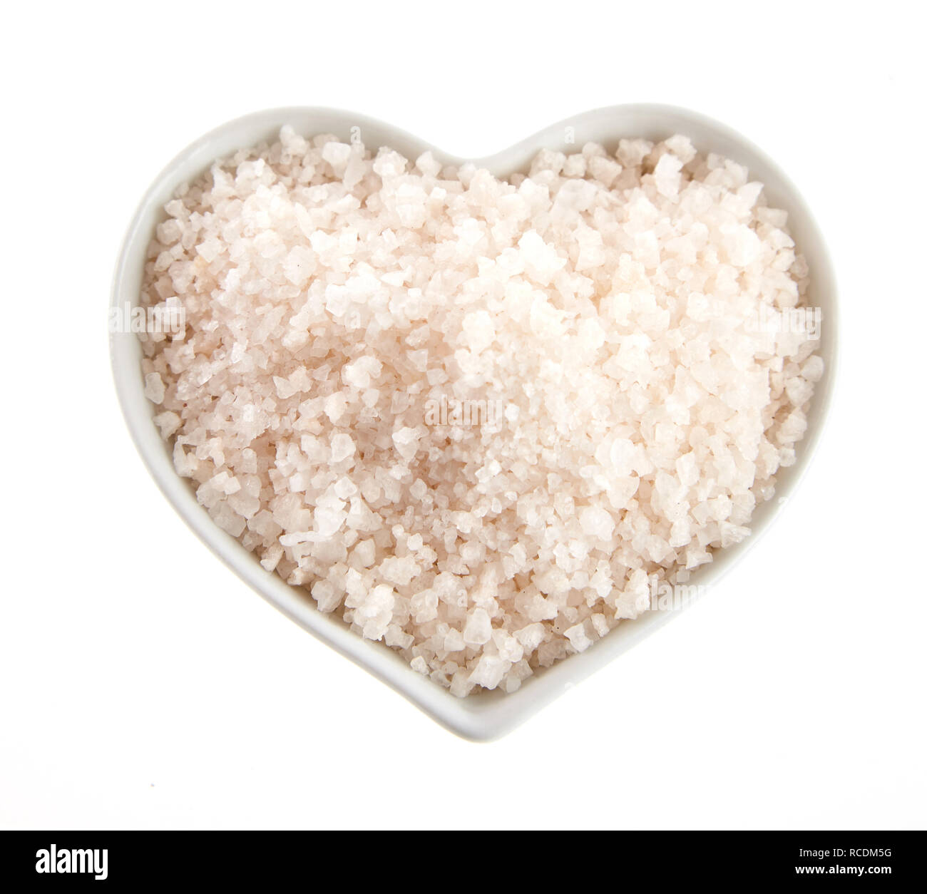Heart-shaped bowl of Himalaya rock salt or halite isolated on white ...