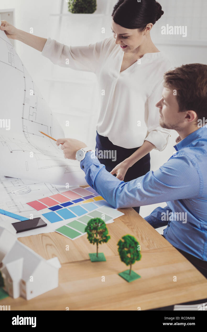 Nice serious man pointing at the drawing Stock Photo - Alamy