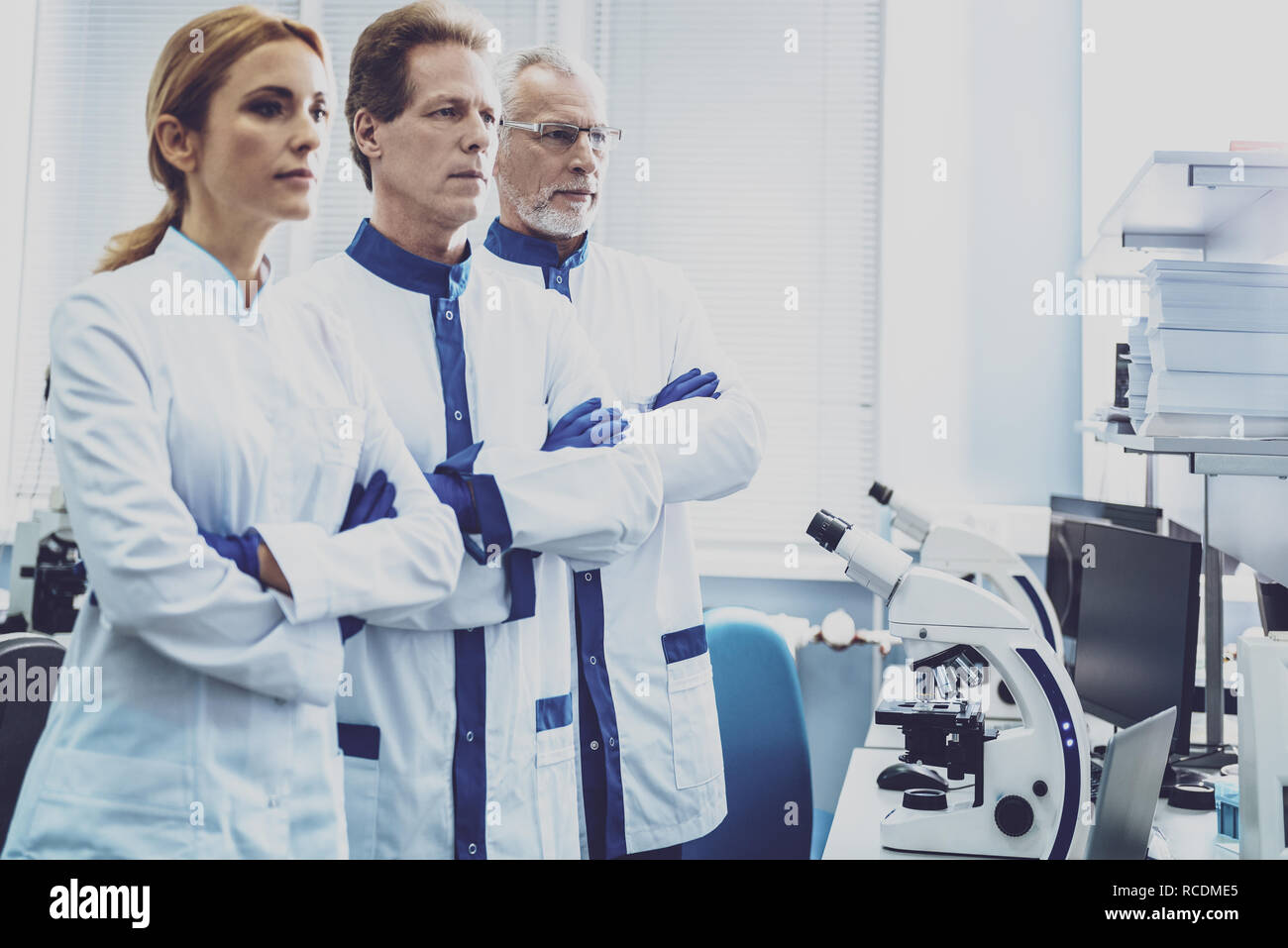 Group of scientists standing in line Stock Photo - Alamy