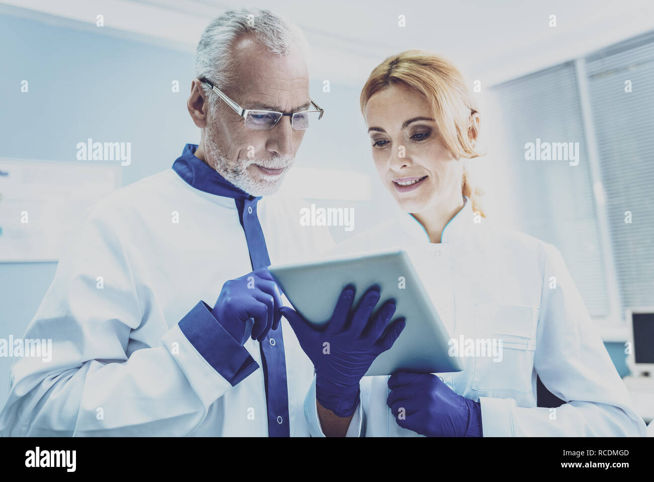 Pleased scientists watching video conference Stock Photo - Alamy