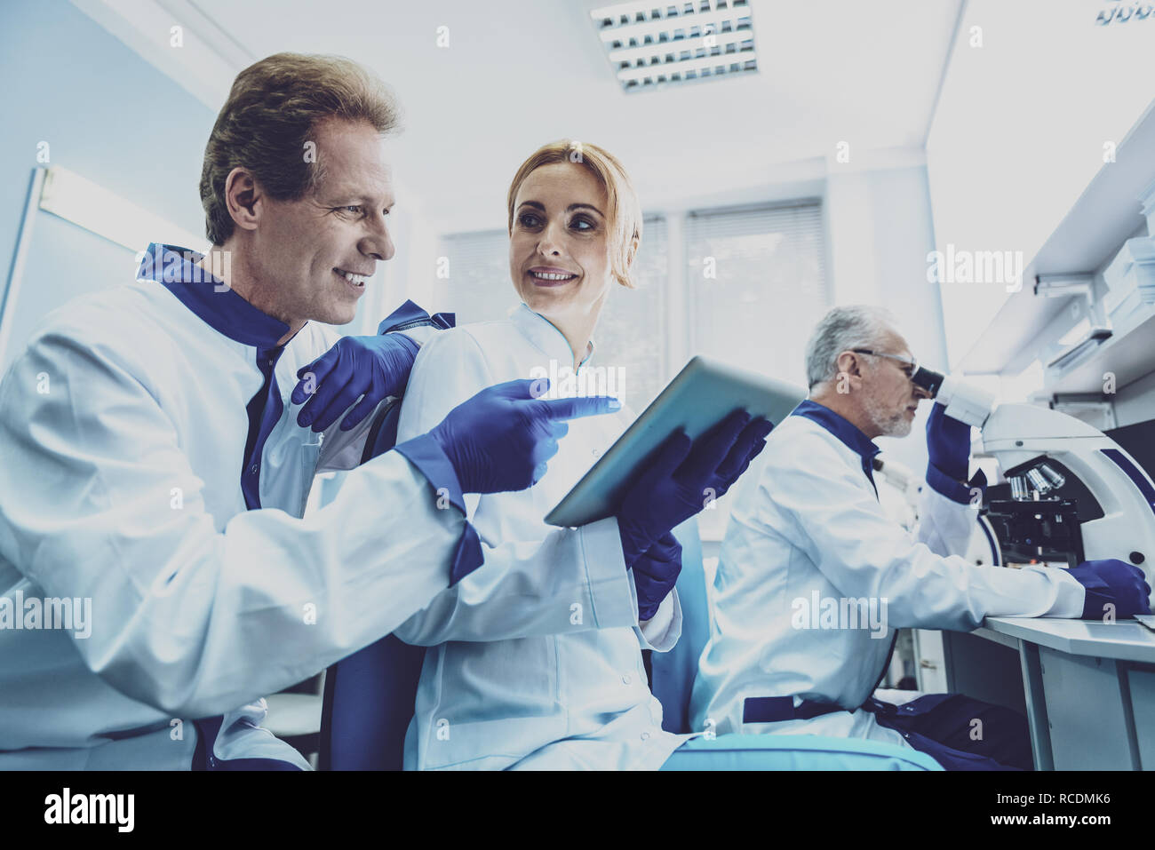 Positive delighted scientists discussing results Stock Photo - Alamy