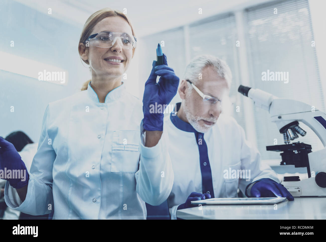 Charming lab assistant enjoying her job Stock Photo - Alamy