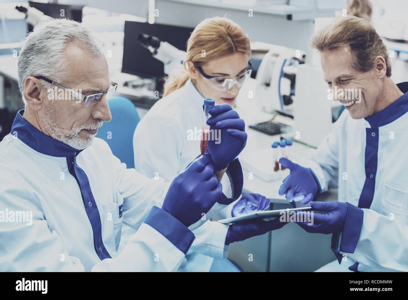 Concentrated bearded scientist looking at reagent Stock Photo - Alamy
