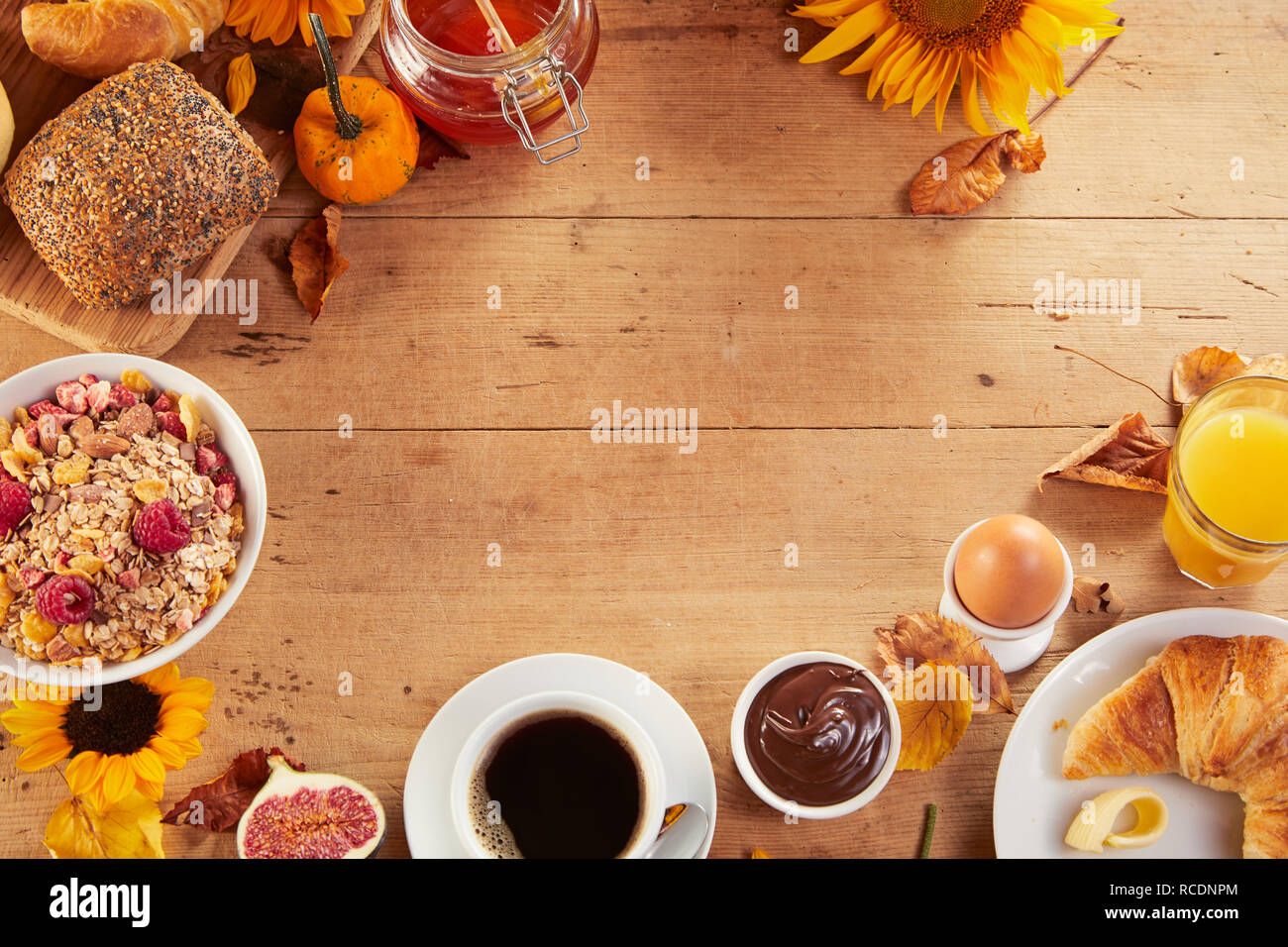 Rustic breakfast meal layout with cup of coffee, muesli, boiled egg ...