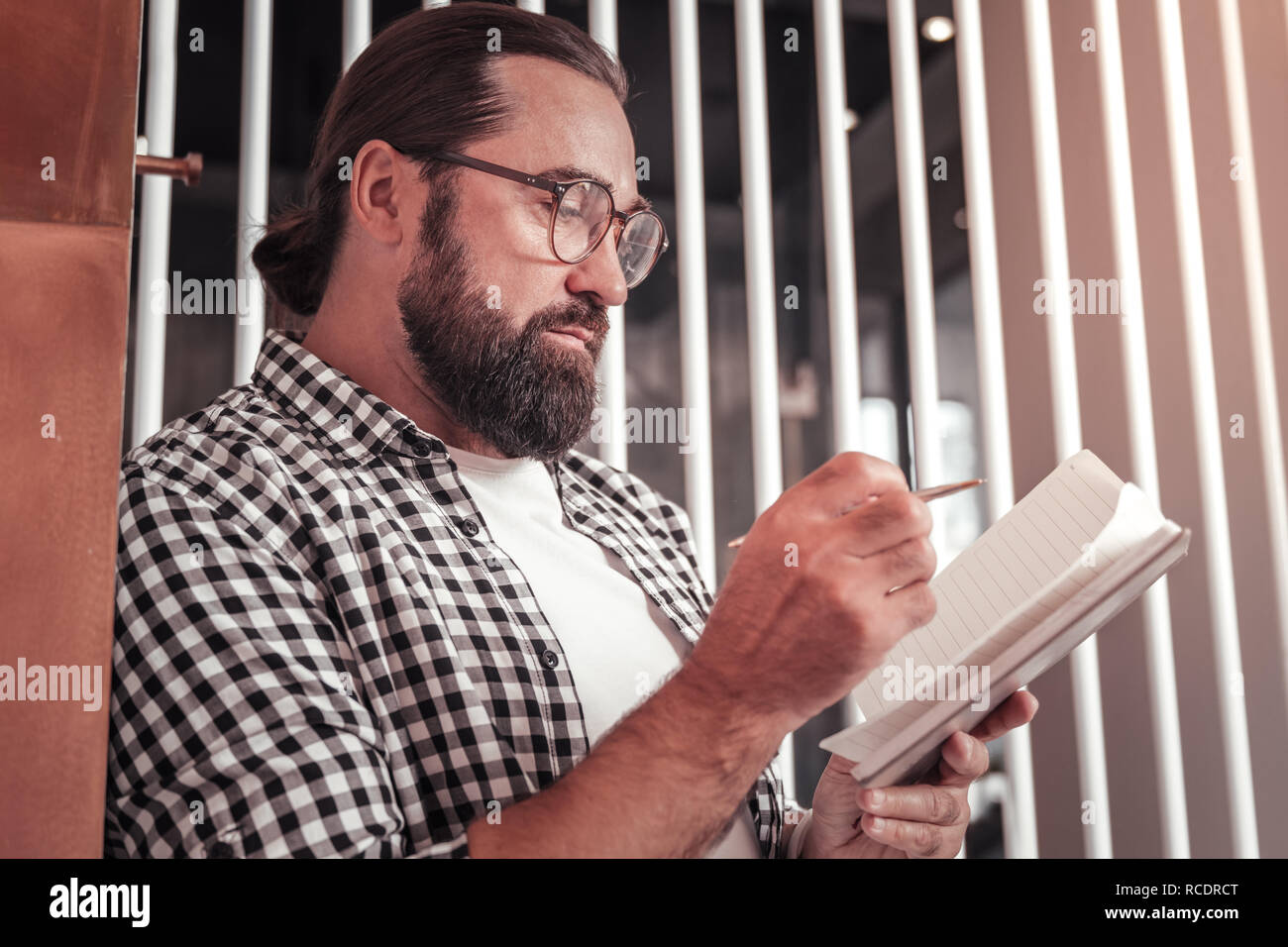 Man making important notes to his notebook Stock Photo - Alamy
