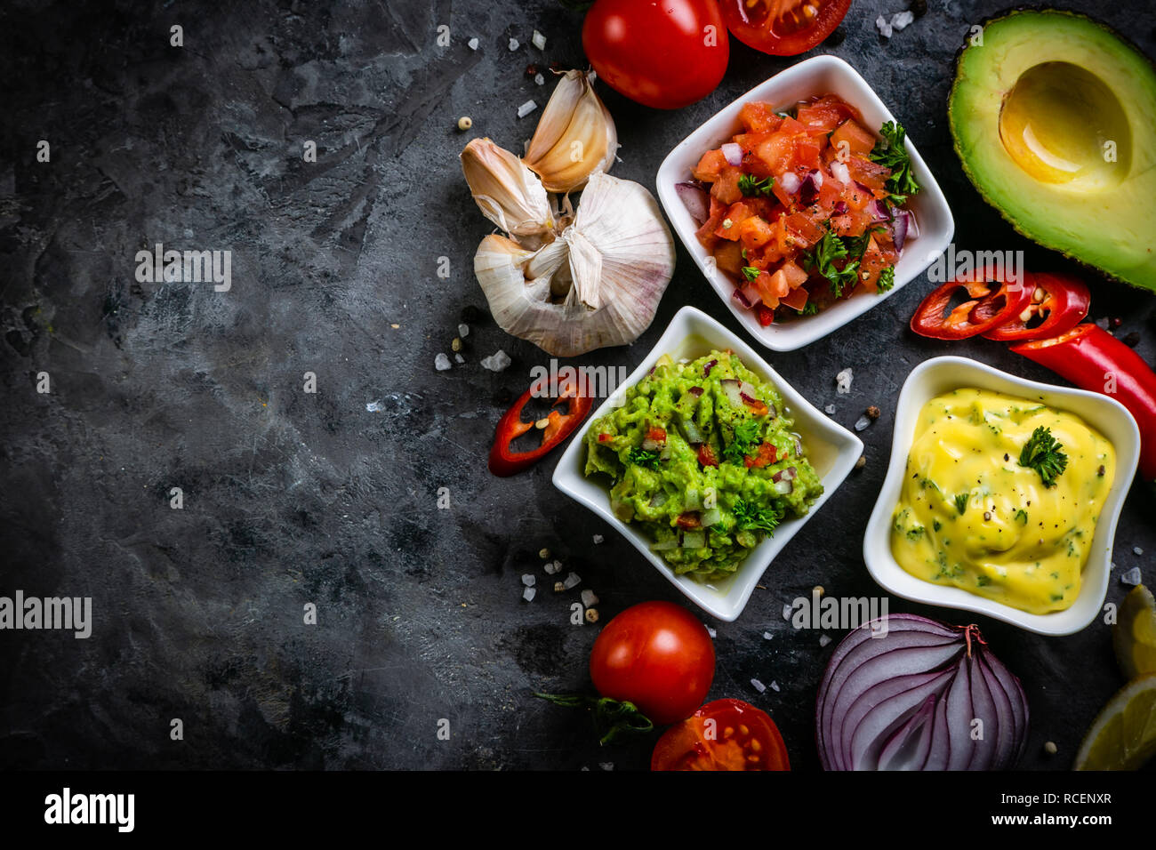 Selection of mexican sauces - salsa, guacamole, cheese sauce and ...