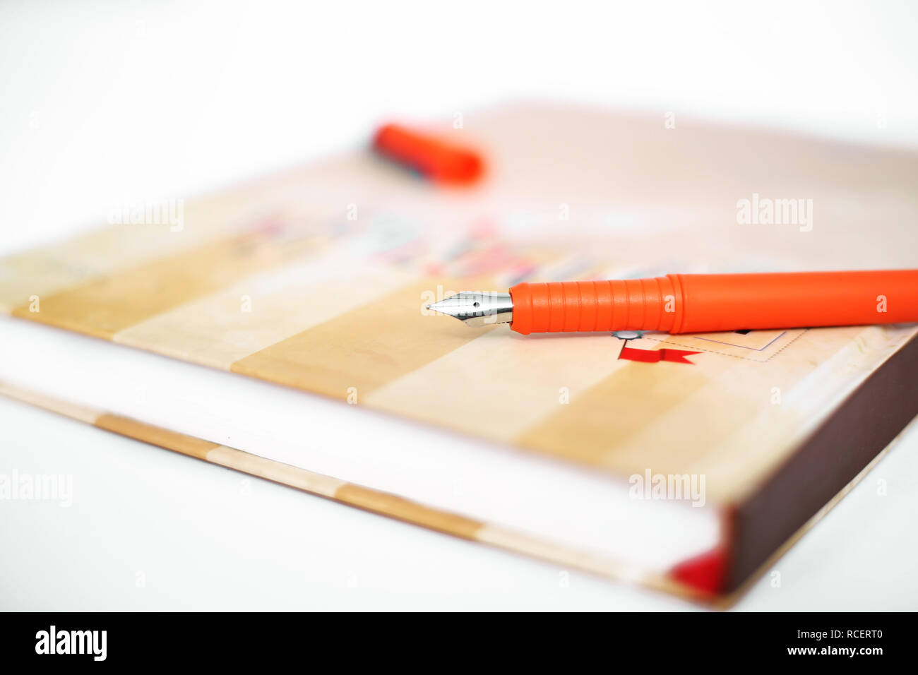 Picture of pen on the closed diary. Isolated on the white background ...