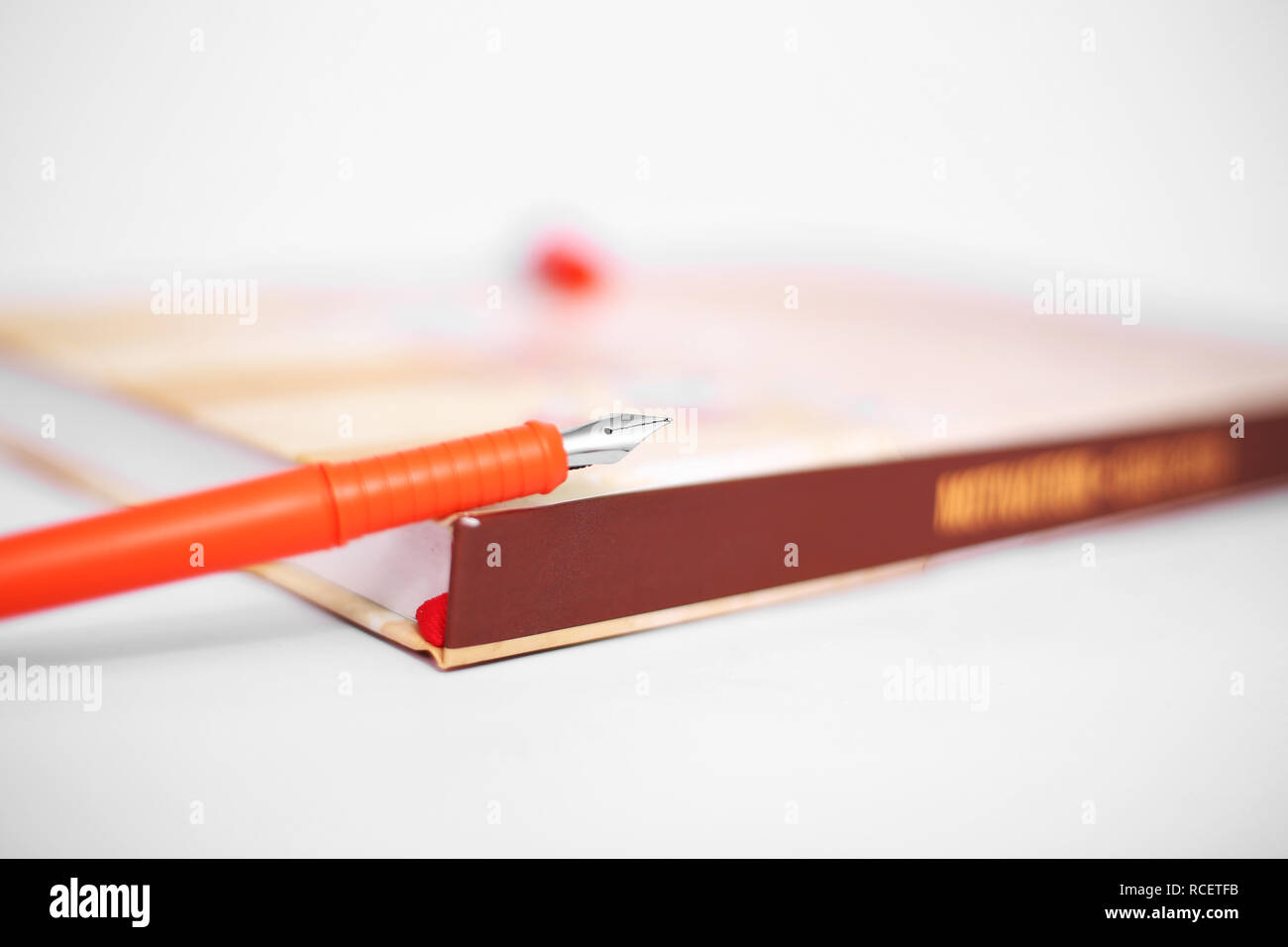 Closed diary with pen. Isolated on the white background Stock Photo - Alamy