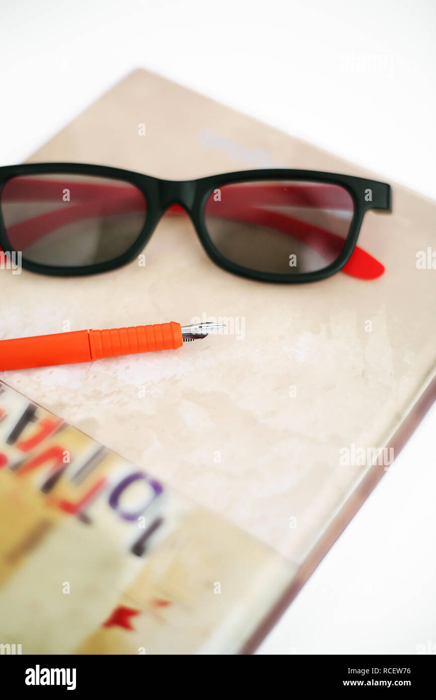 Closed diary with glasses and pen. Isolated on the white background ...