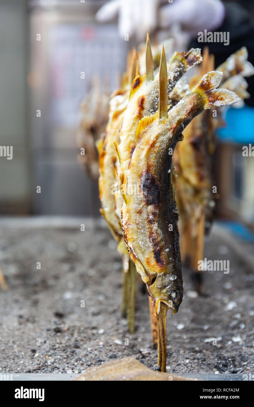 Grilled Ayu fish with salt at Kegon Waterfall, Nikko, Japan Stock Photo ...