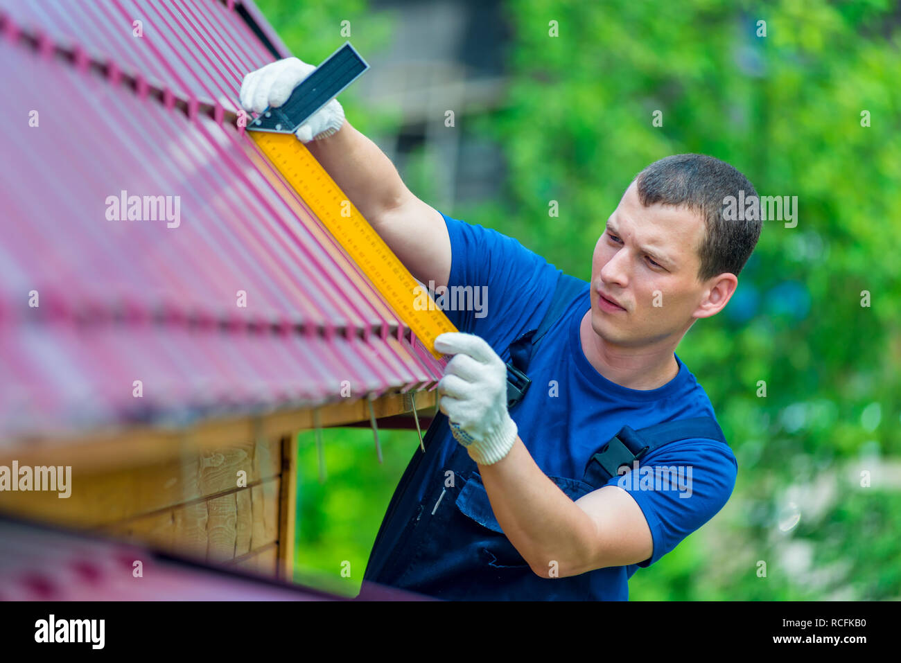 Professional worker repairs the roof of a residential building Stock ...