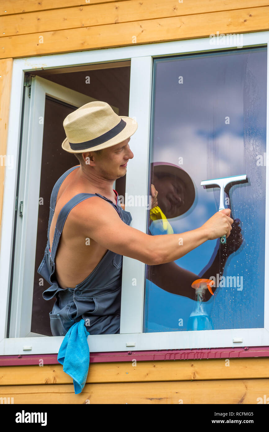 A window cleaner during work, cleaning the glass Stock Photo - Alamy