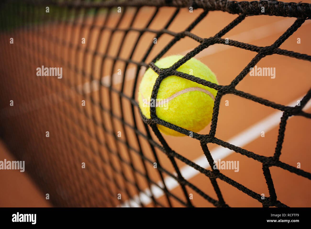 Tennis ball hitting the tennis net on tennis court. Failure concept ...