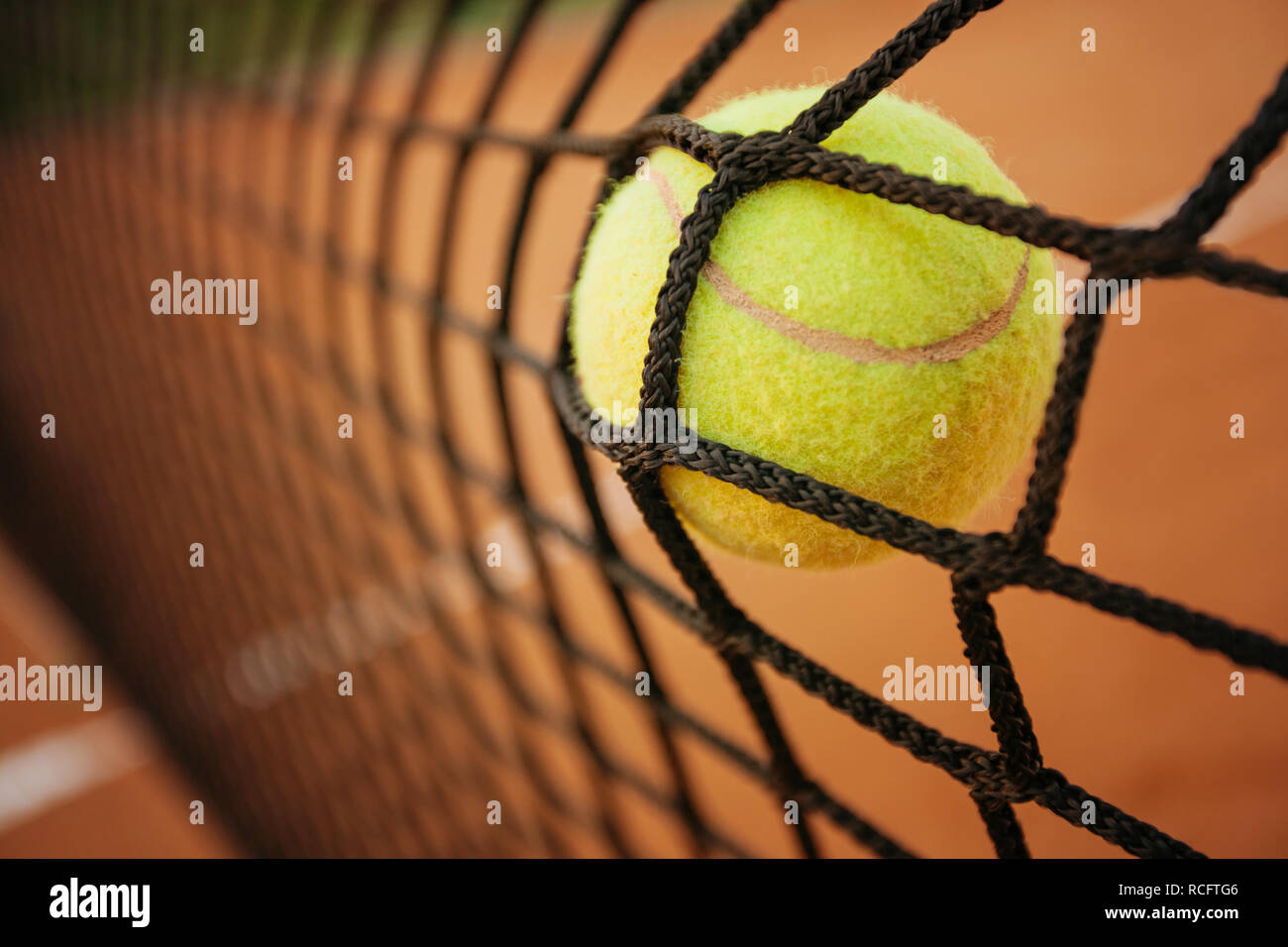 Tennis ball hitting the tennis net on tennis court Stock Photo - Alamy