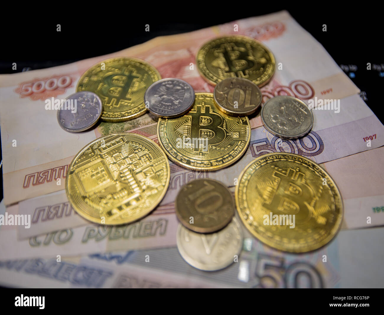 Golden bitcoin coin on russian ruble close up. Symbolic image of ...