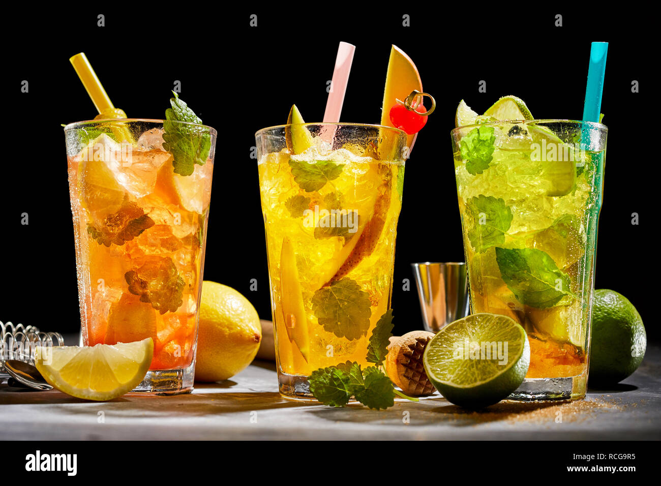 Assorted fresh fruit cocktails blended with alcohol and mint leaves and ...
