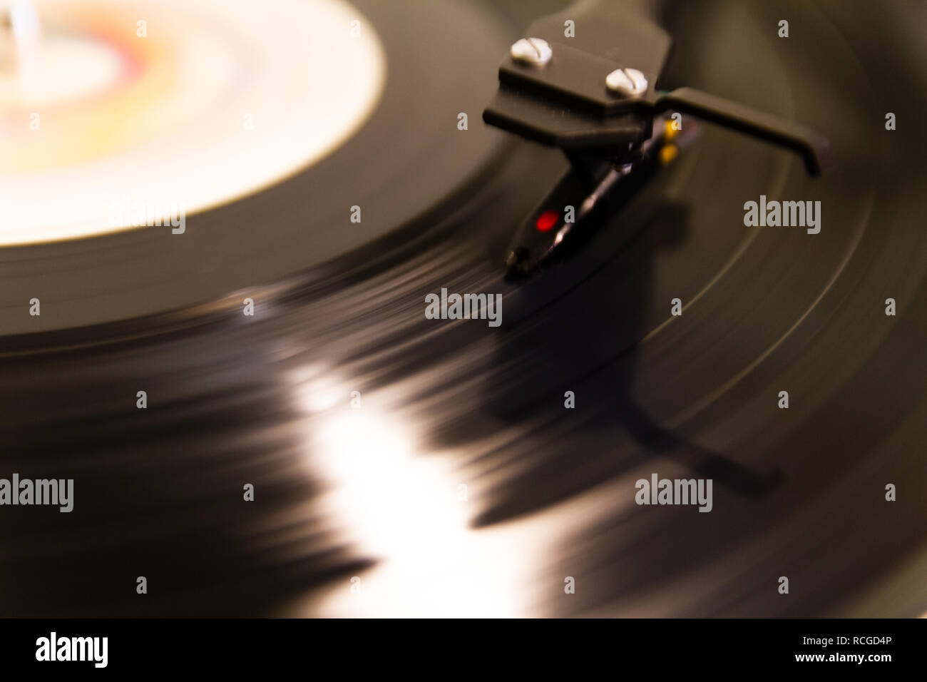 Vinyl lp record playing on a turntable isolated Stock Photo - Alamy